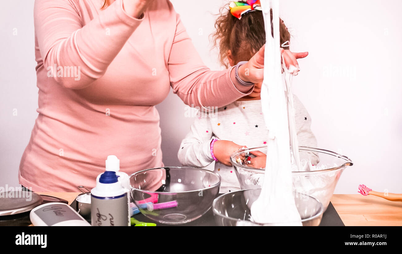 Step by step. Mother and daughter making colorful fluffy slime Stock ...