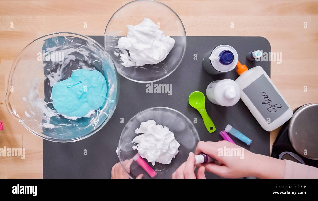 Step by step. Flat lay. Mother and daughter making colorful fluffy ...