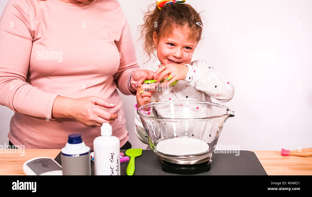 Step by step. Mother and daughter making colorful fluffy slime Stock ...