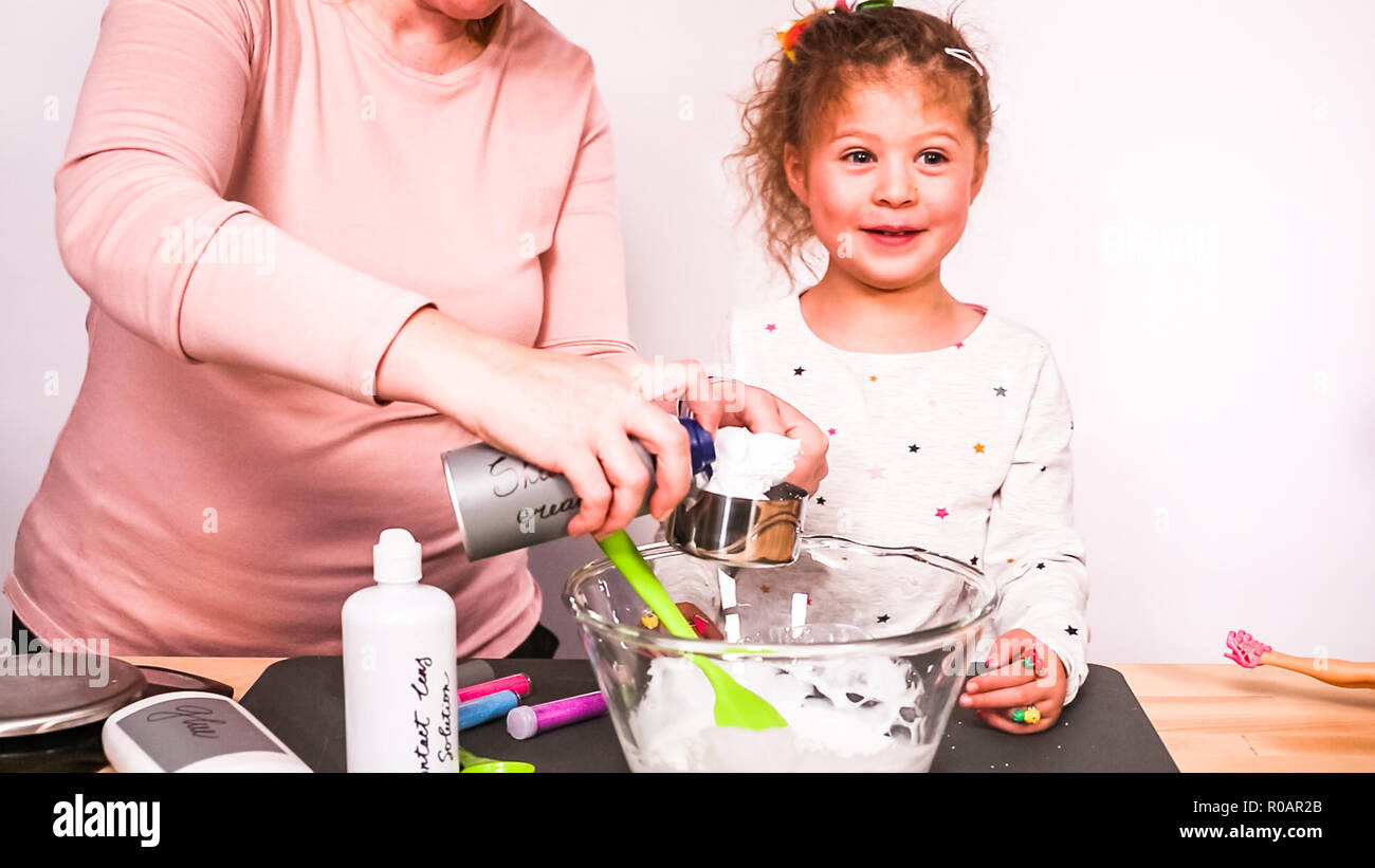 Step by step. Mother and daughter making colorful fluffy slime Stock ...