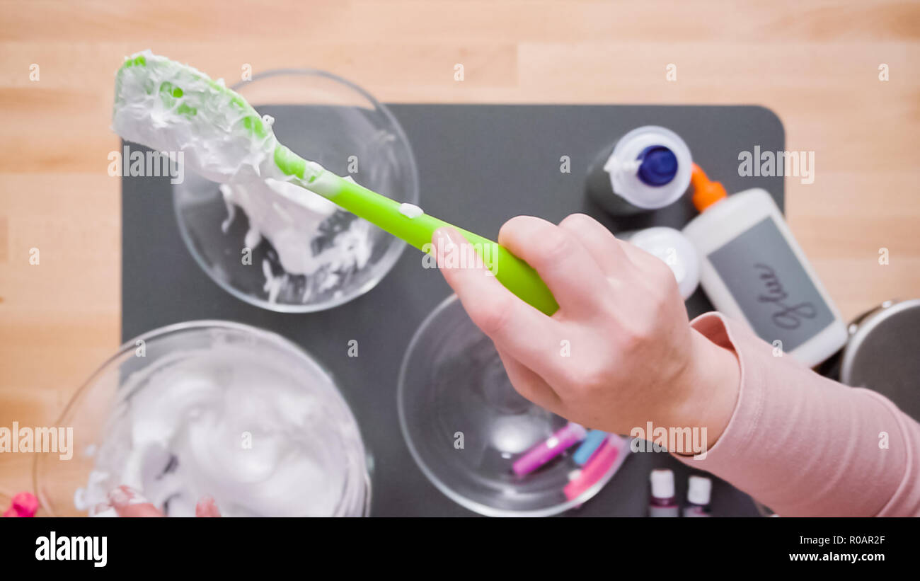 Step by step. Flat lay. Mother and daughter making colorful fluffy ...