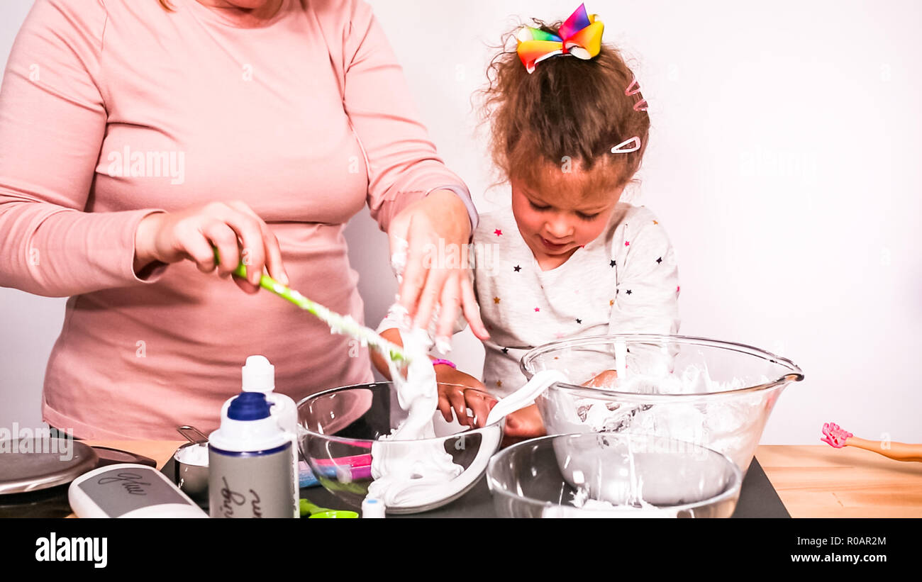 Step by step. Mother and daughter making colorful fluffy slime Stock ...