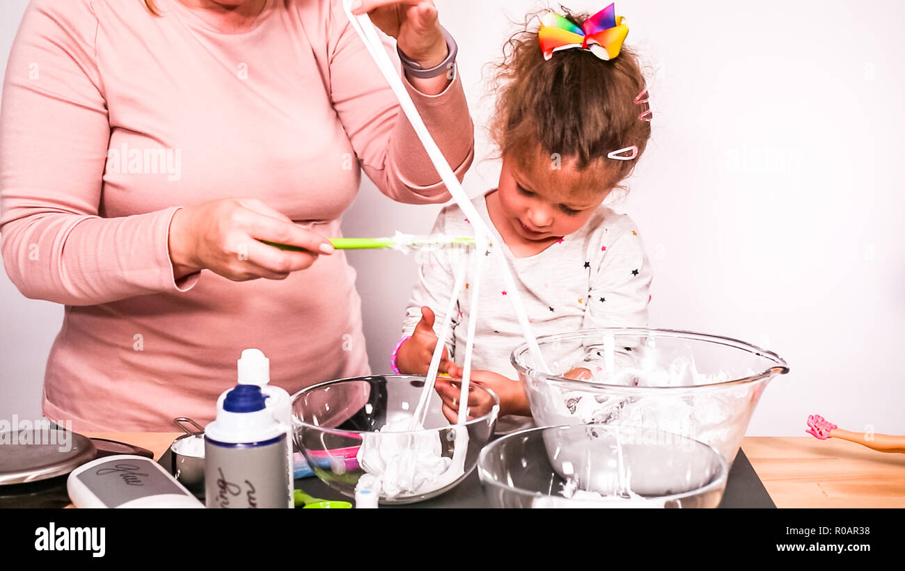 Step by step. Mother and daughter making colorful fluffy slime Stock ...