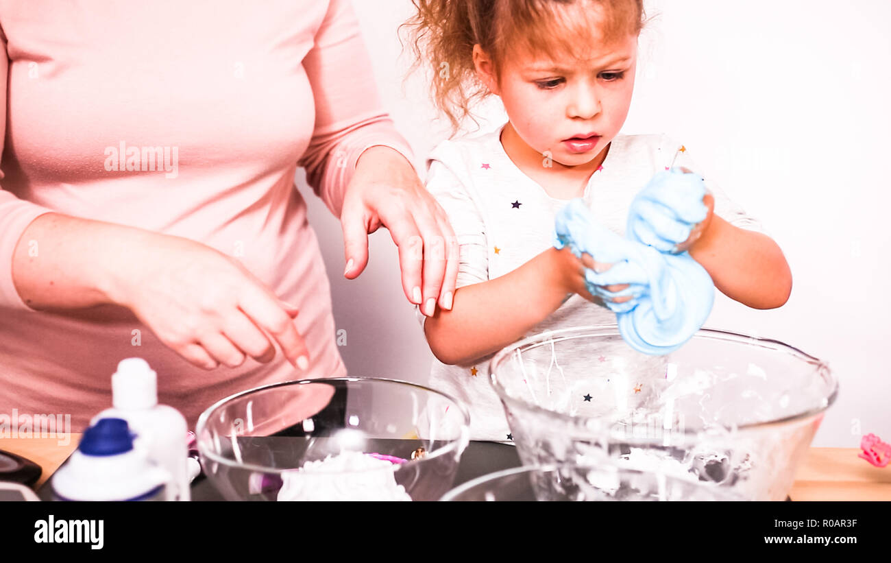 Step by step. Mother and daughter making colorful fluffy slime Stock ...