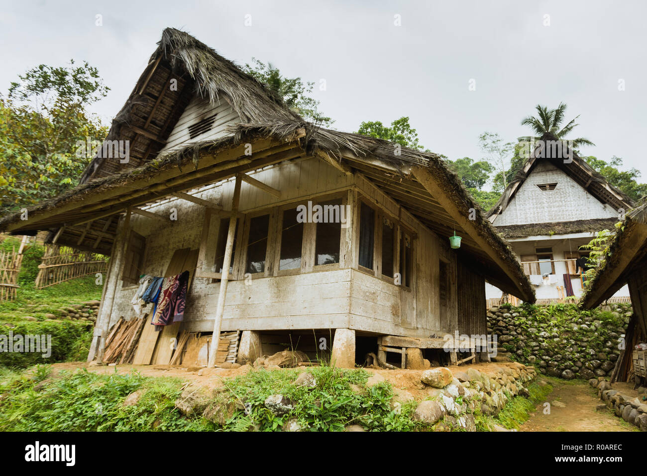Traditional wooden houses with triangular roof surrounded by green ...