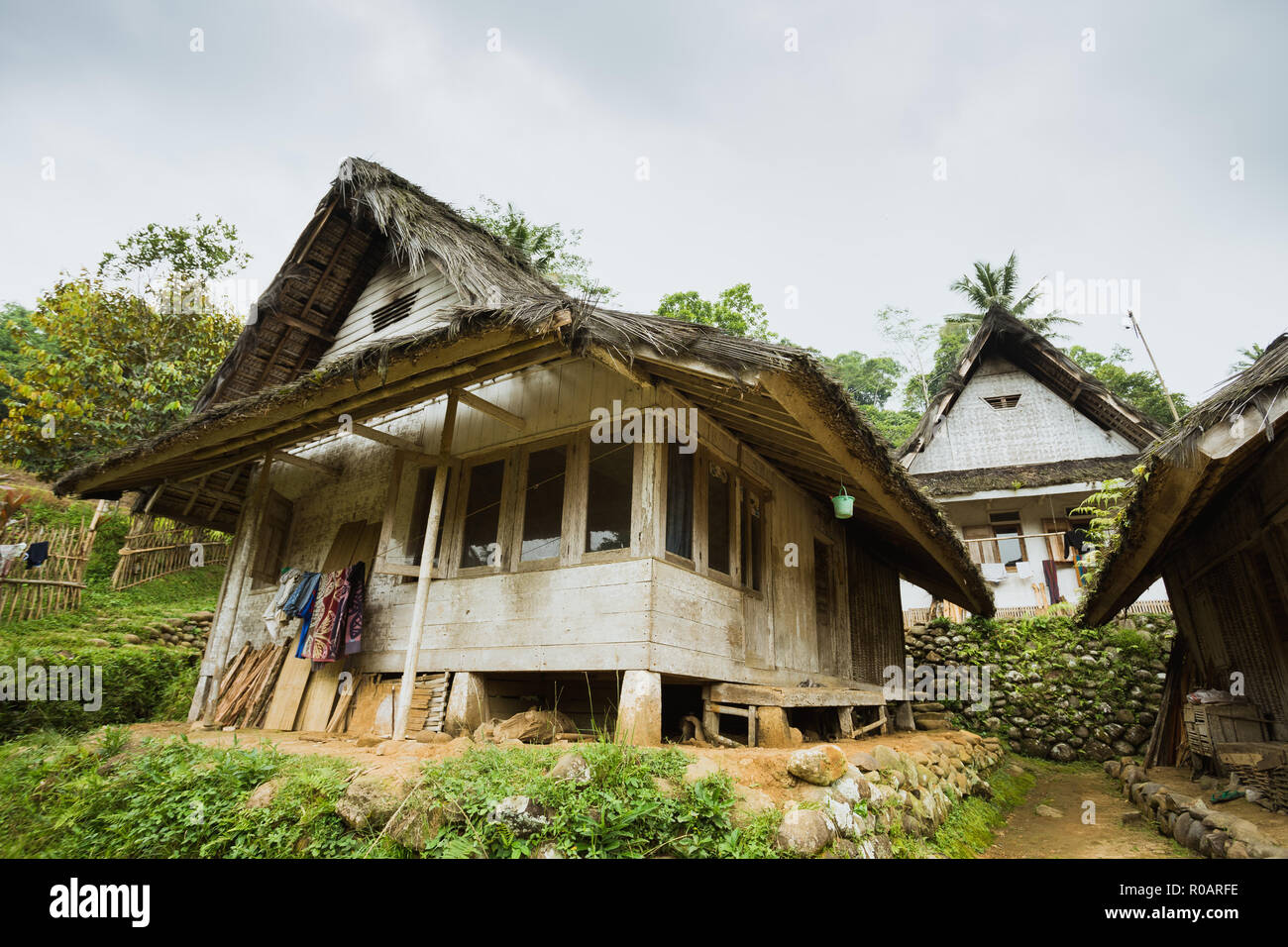 Traditional wooden houses with triangular roof surrounded by green ...