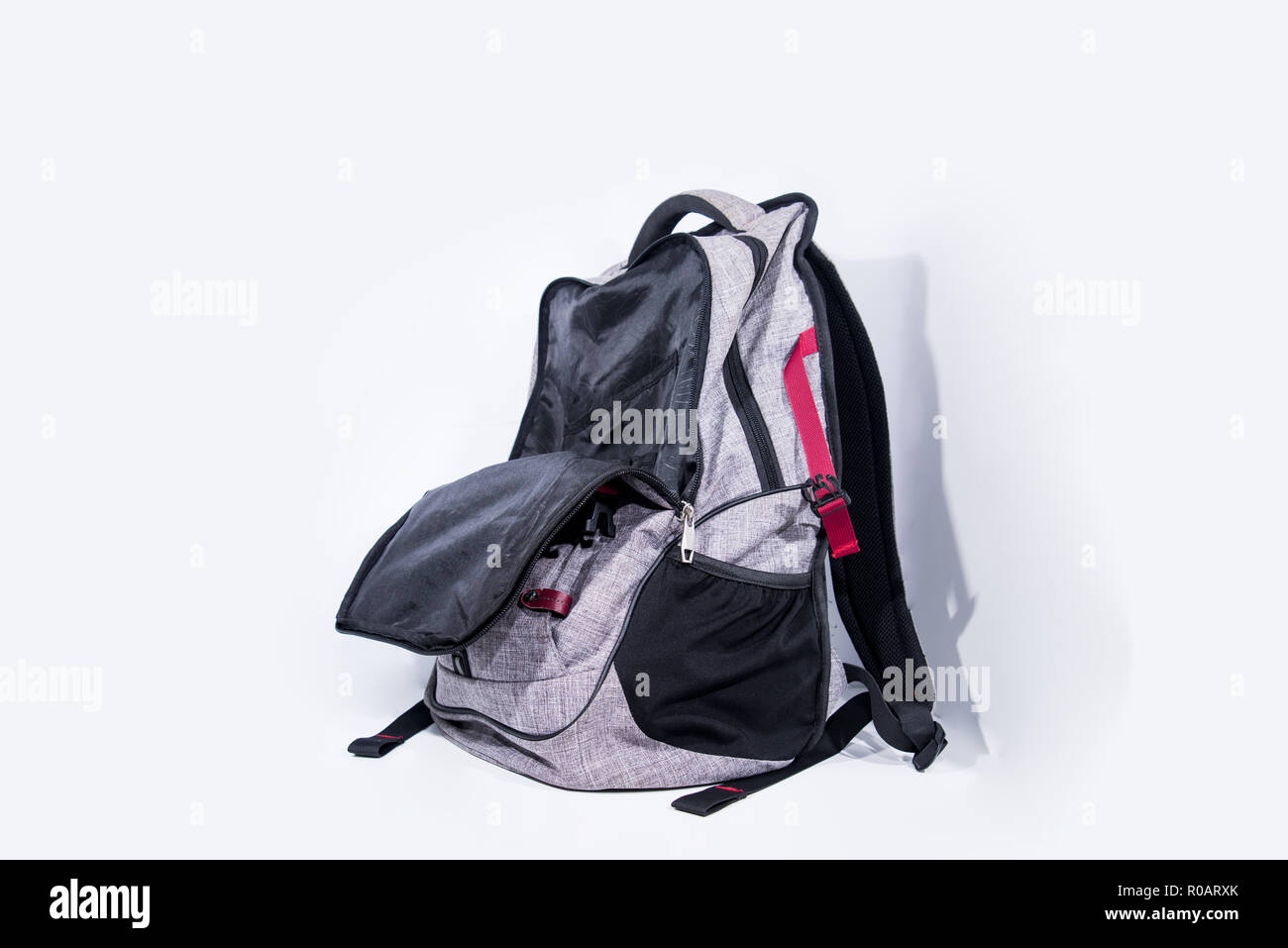 Empty gray backpack isolated on white background Stock Photo - Alamy
