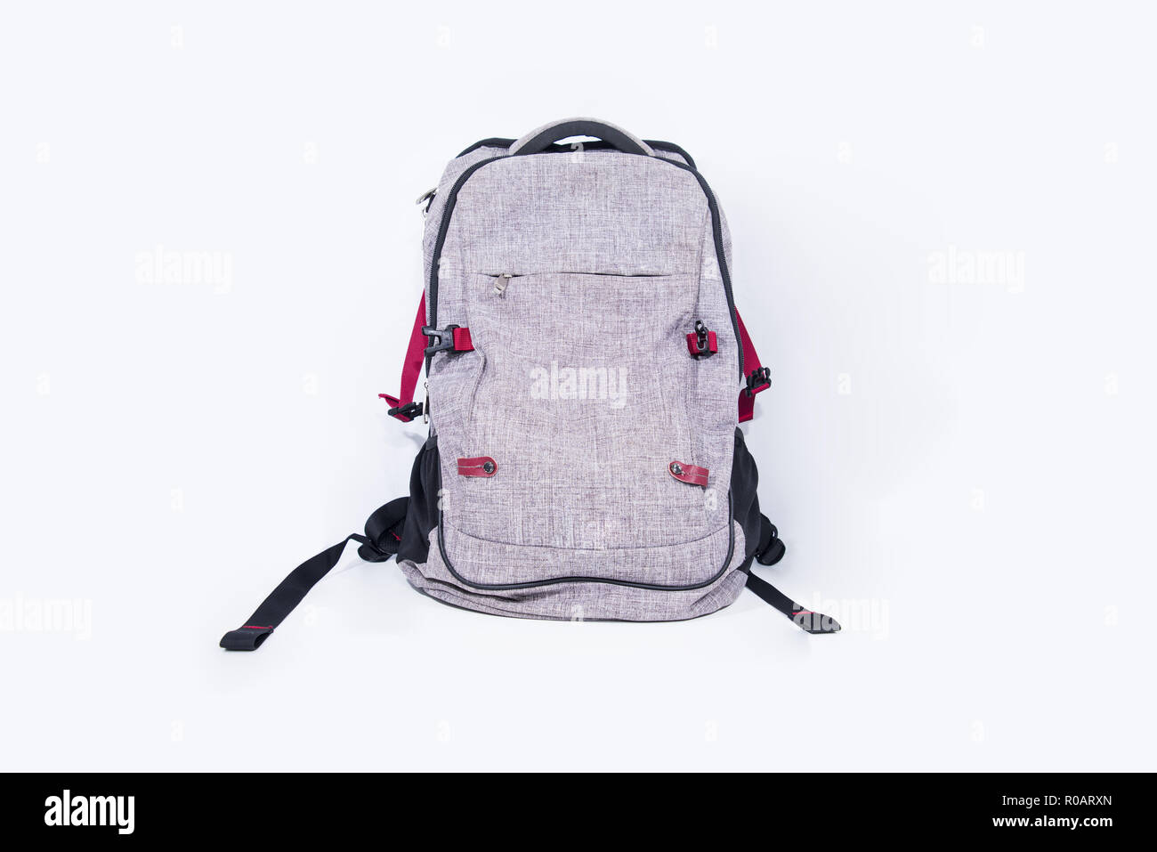 Empty gray backpack isolated on white background Stock Photo - Alamy