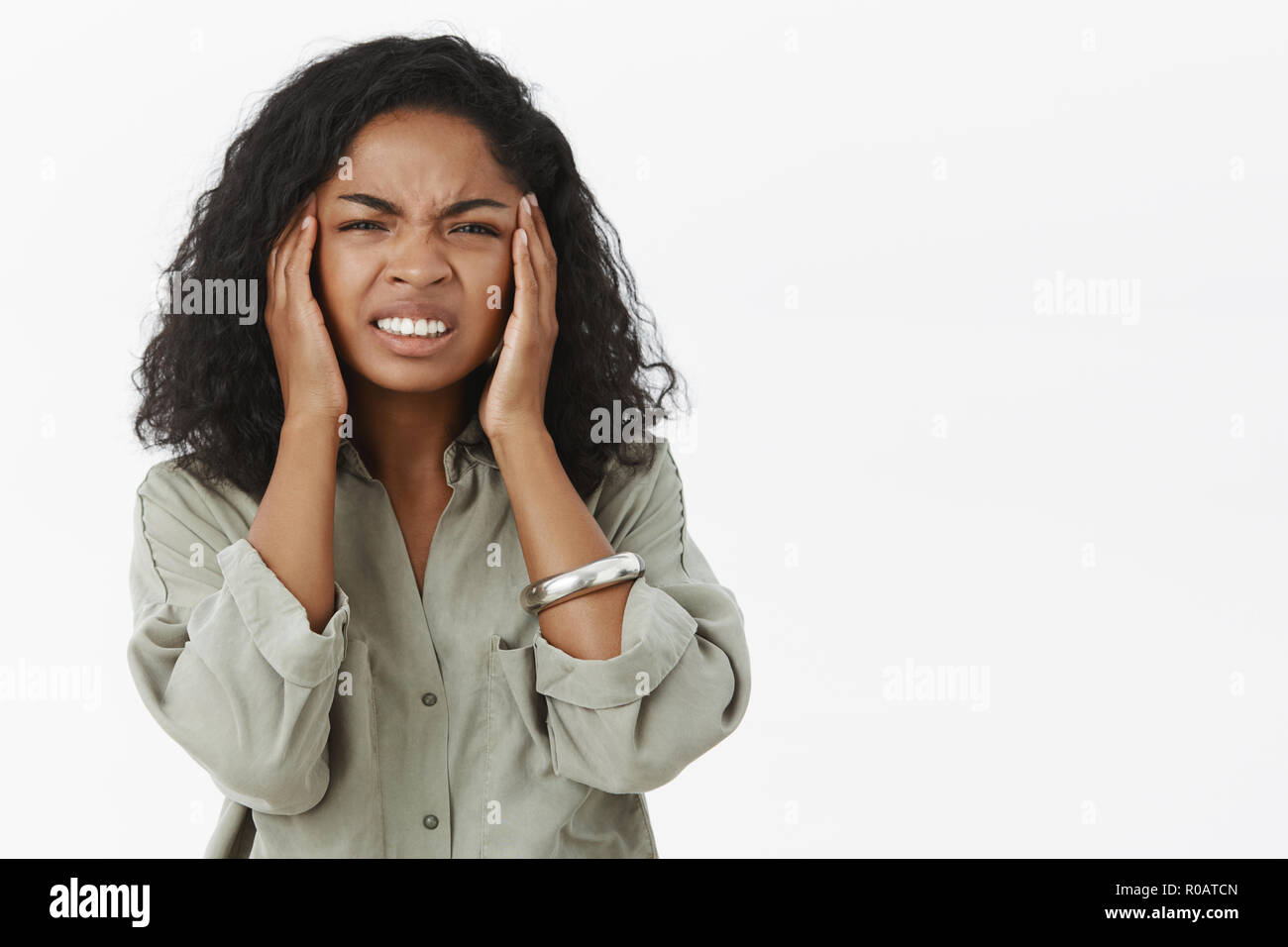 Head goes round from hangover. Portrait of displeased intense african ...