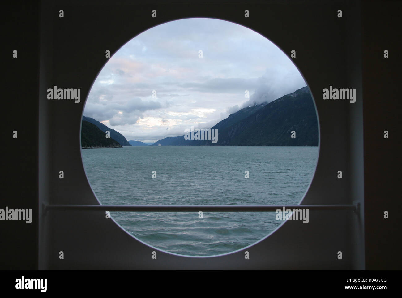 View through a circular porthole of Alaska's Inside Passage from a ...