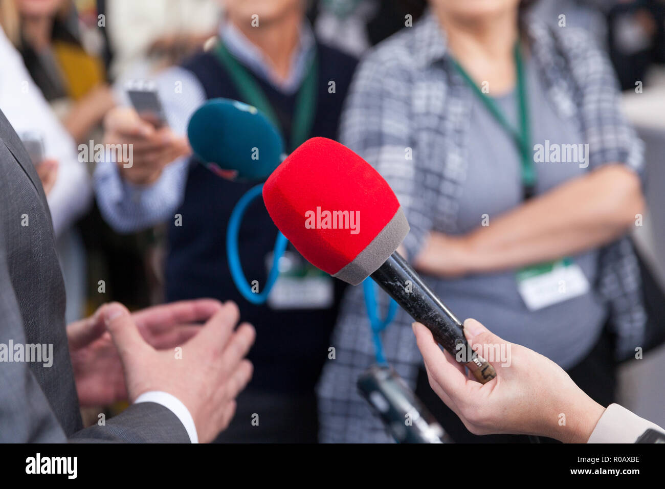 An unrecognizable businessman or politician, with visible hand gestures ...