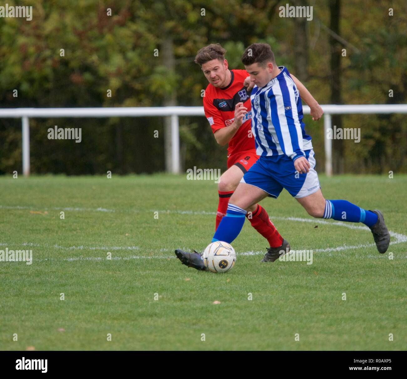 Football action from an amateur match between Whaley Bridge Athletic ...