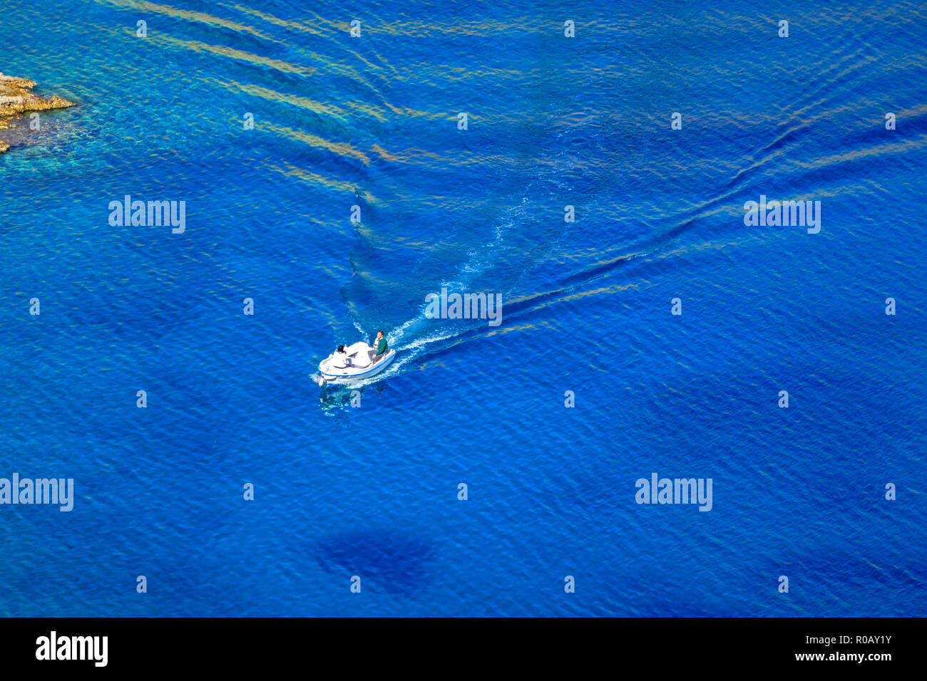 Small white boat on blue sea with waves, at holiday destination ...