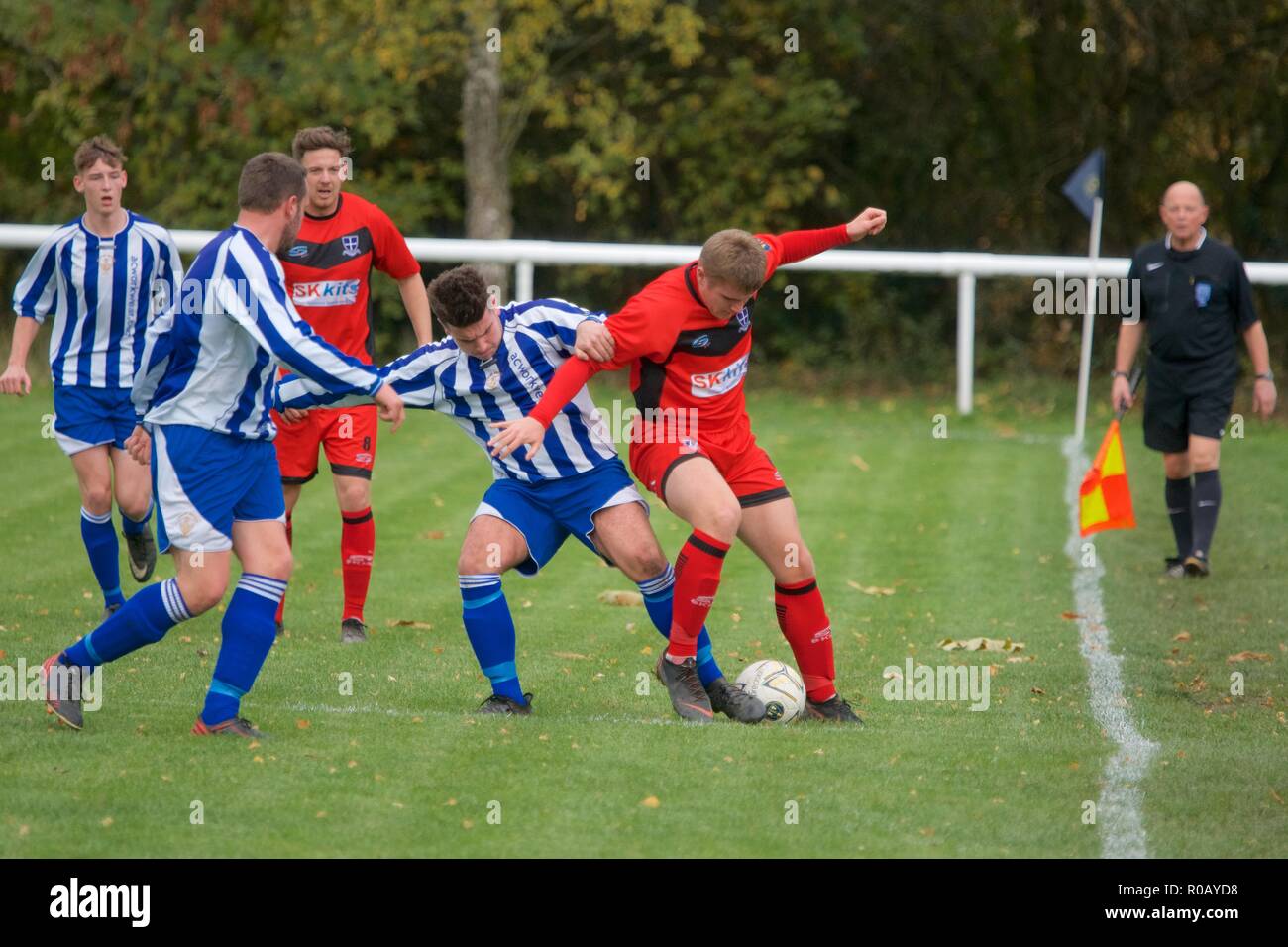 Football action from an amateur match between Whaley Bridge Athletic ...