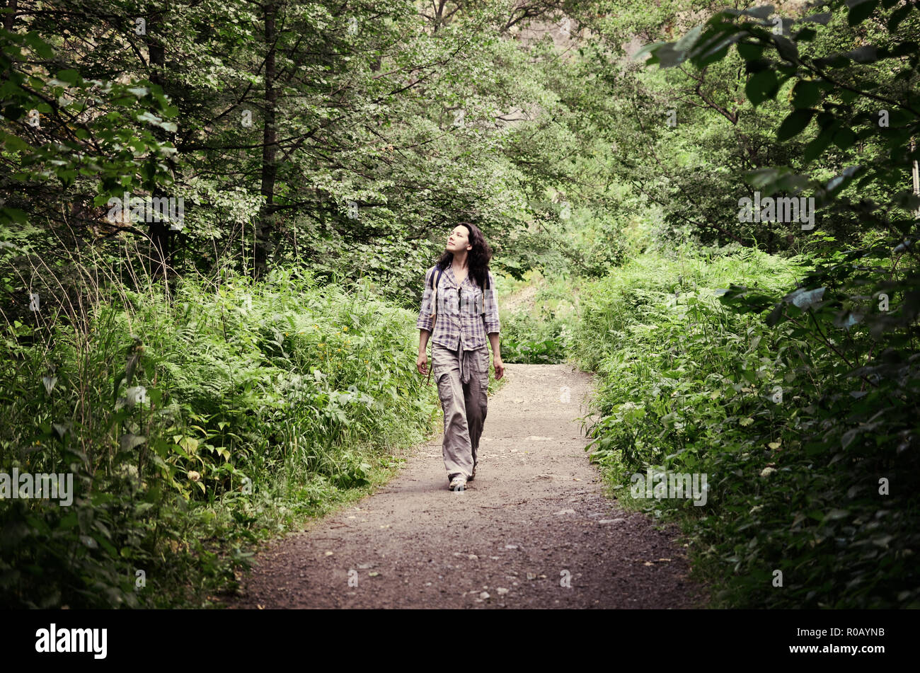 Woman walking along road in hi-res stock photography and images - Alamy