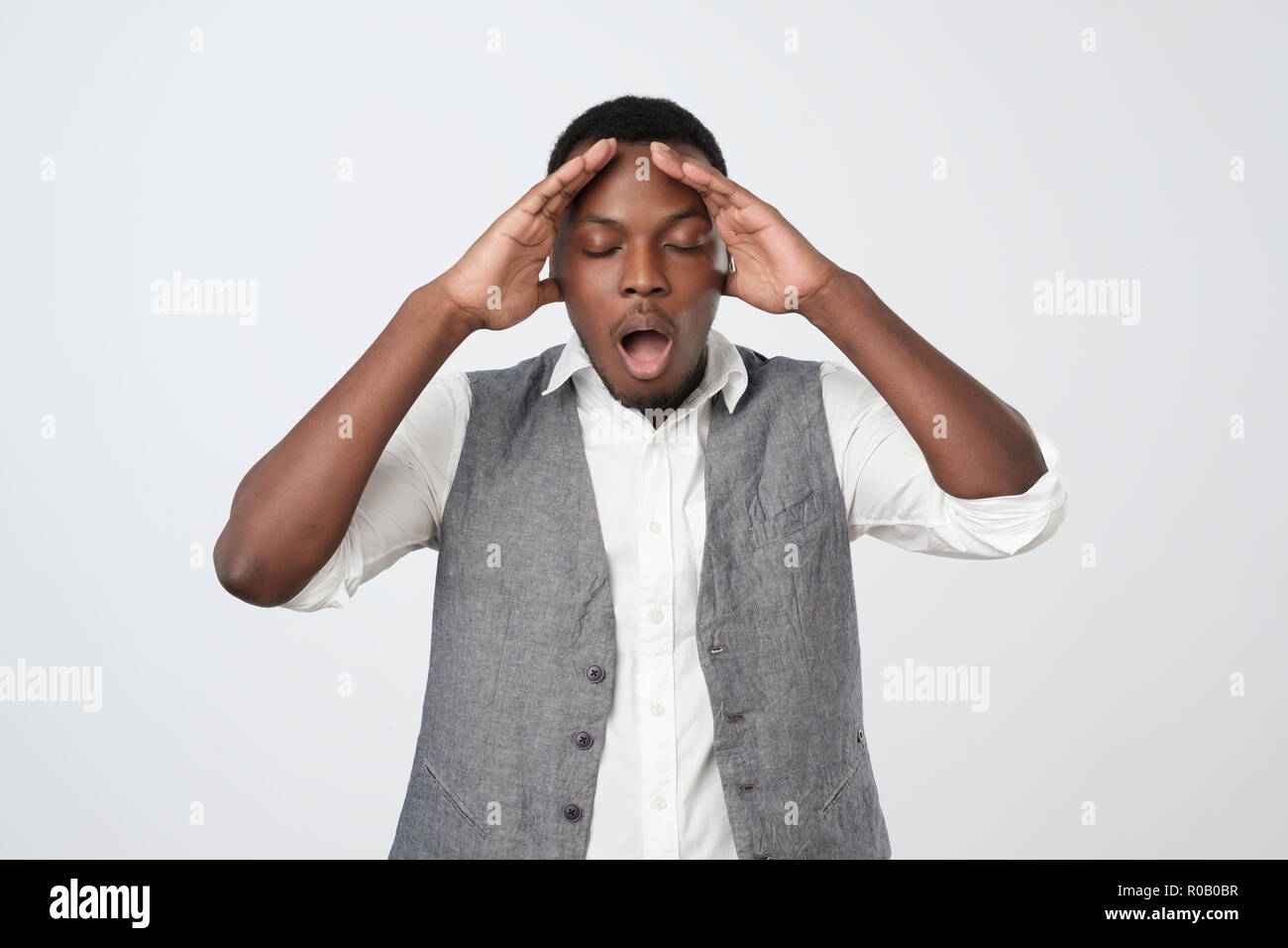 African young man, slapping hand on head having a duh moment isolated ...