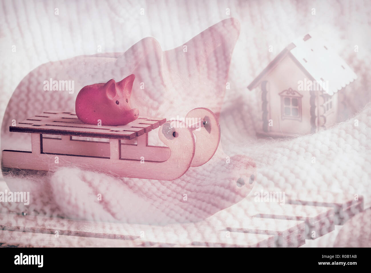 Symbol of the year by the horoscope, small toy pig on a wooden sled on ...