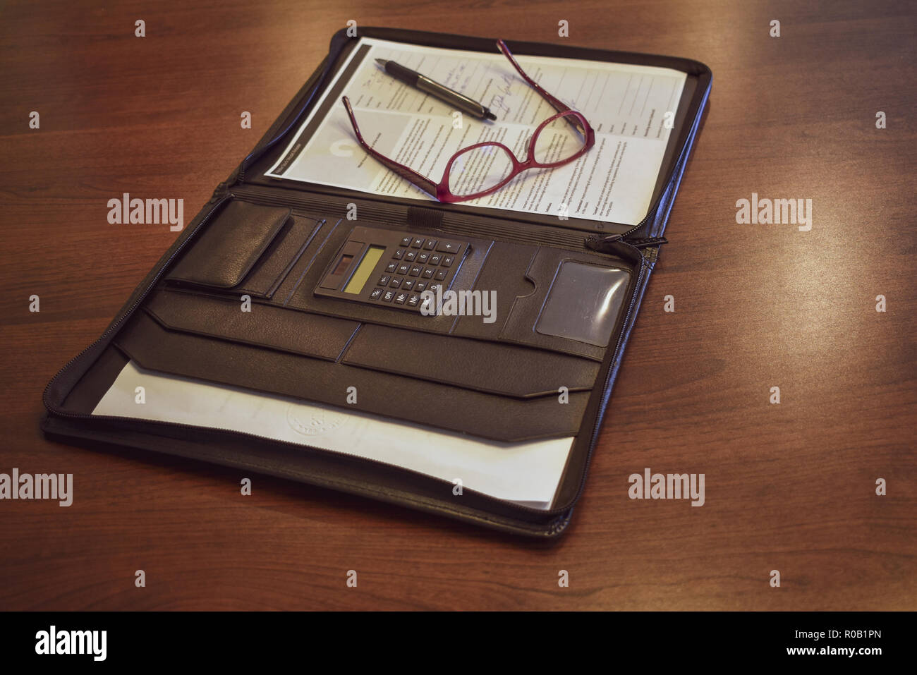Desk with paperwork and glasses Stock Photo - Alamy