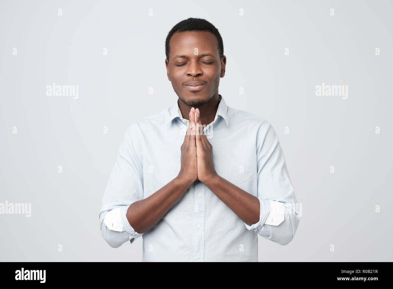 African young guy asking for a favor. Please cover me at work Stock ...