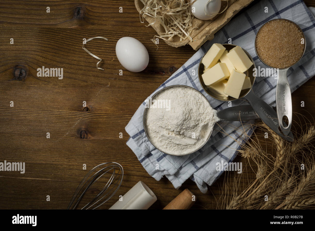 Baking ingredients in measuring cups, rustic wood background Stock ...