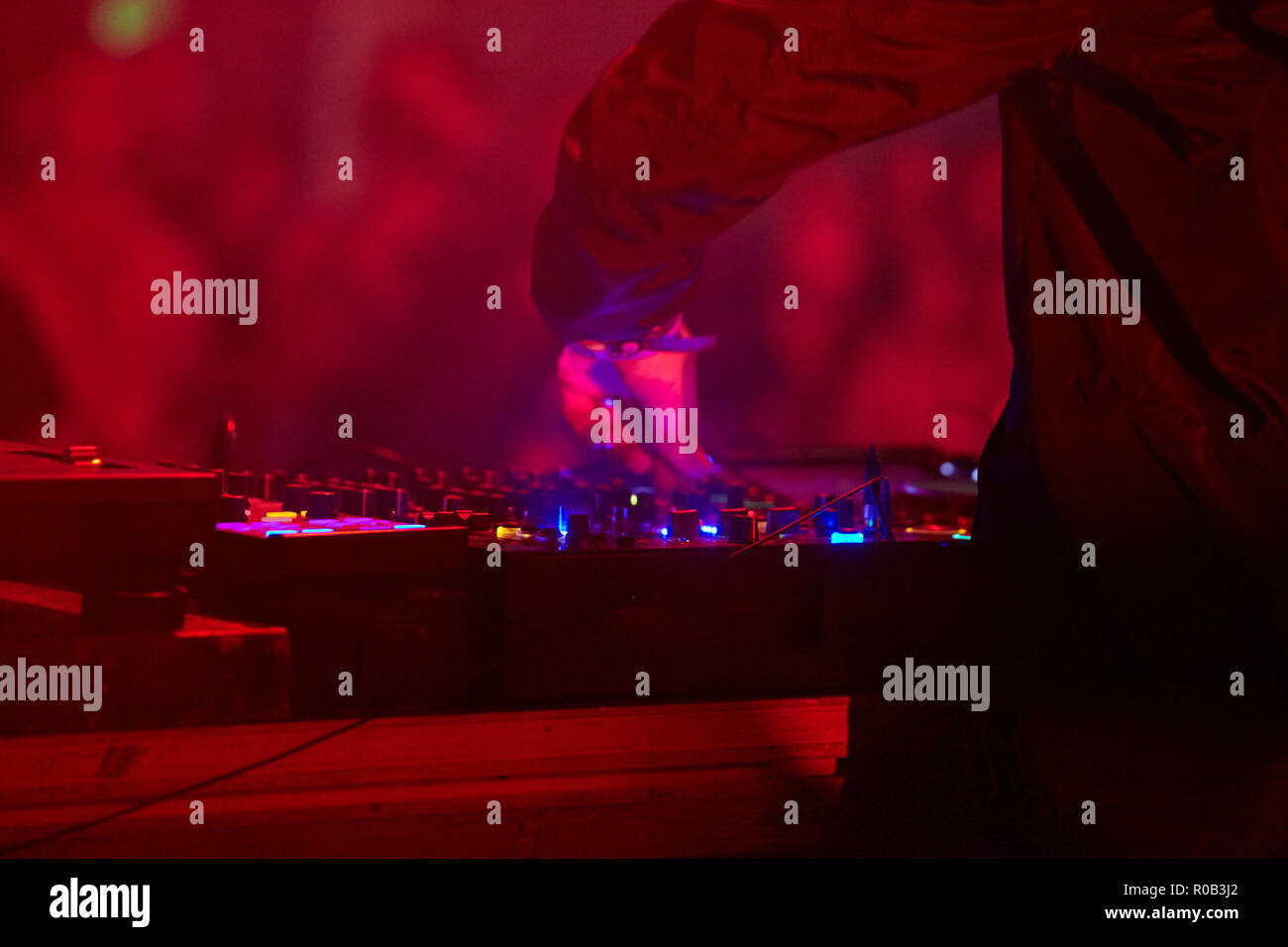 dj playing, music equipment, party. colorful red lights Stock Photo - Alamy