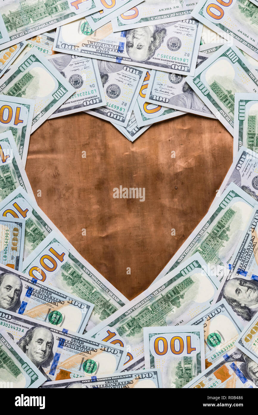 Copper bronze heart shape in center of dollar money background Stock ...