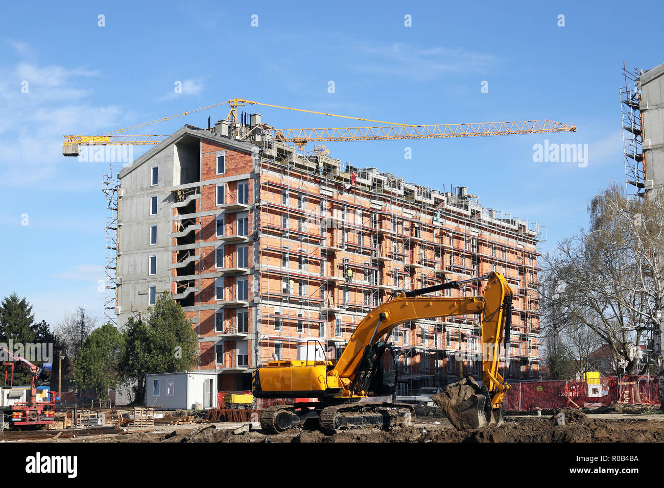 Excavator on new building construction site Stock Photo - Alamy