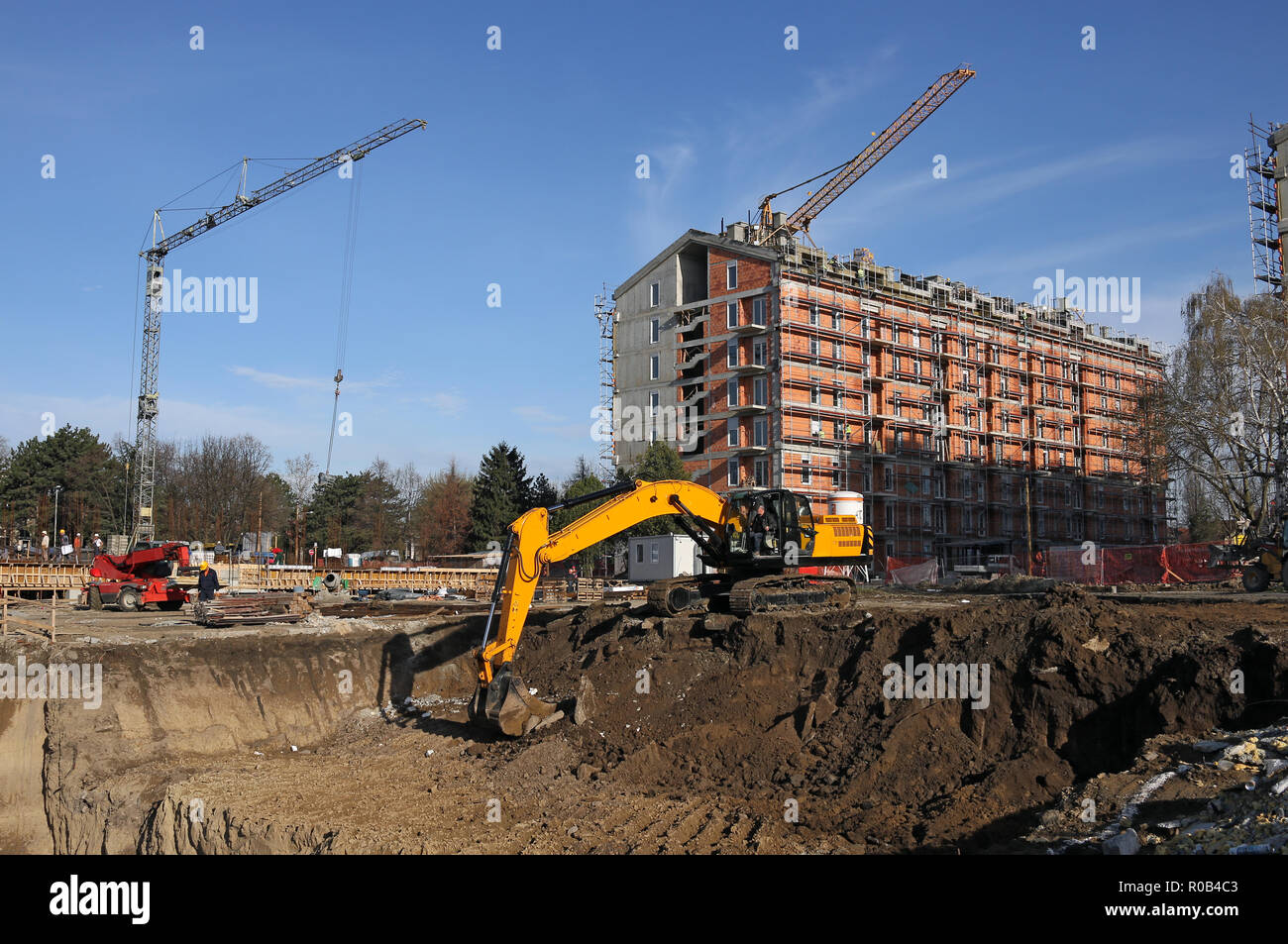 The excavator digs the foundation on the construction site Stock Photo ...