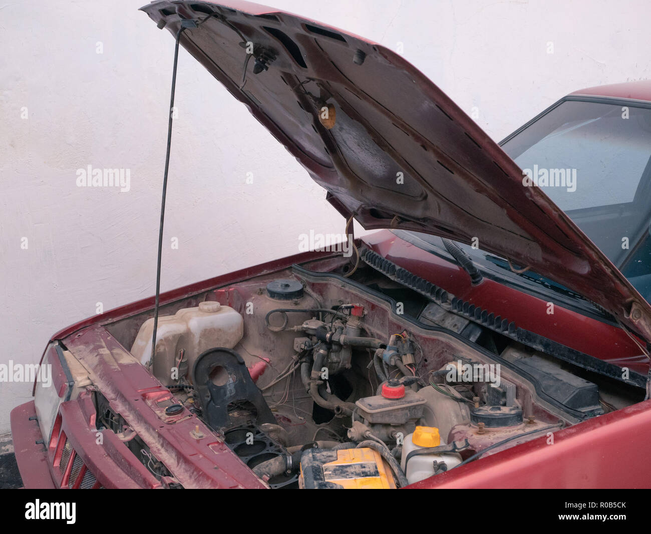 opened car hood with visible parts but without engine. mechanic fix ...