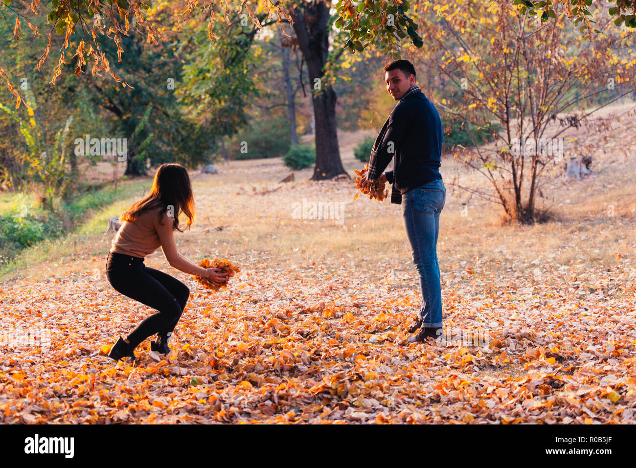ouple having a leaf fight smiling and enjoying their time Stock Photo ...