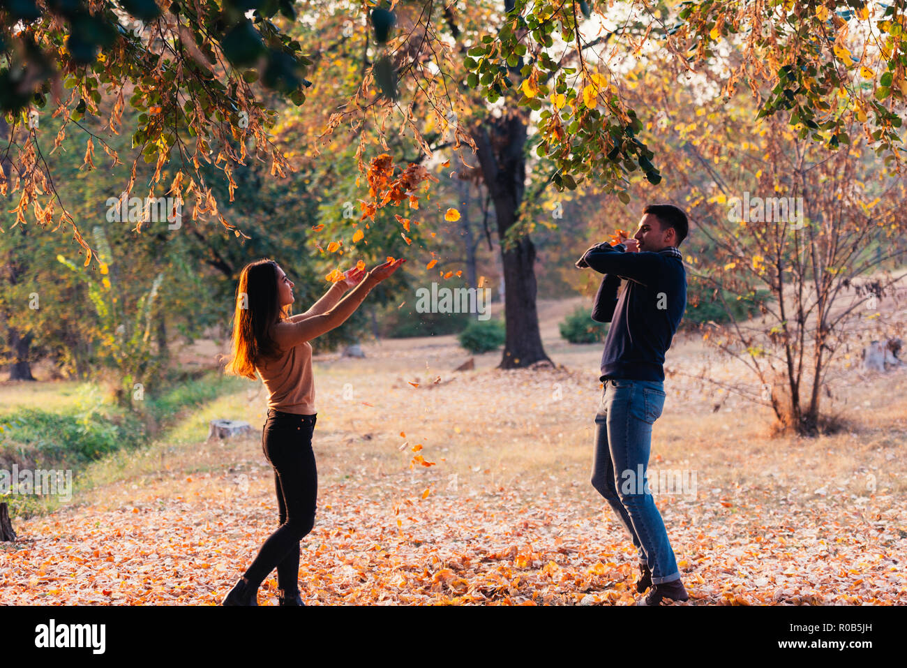 ouple having a leaf fight smiling and enjoying their time Stock Photo ...
