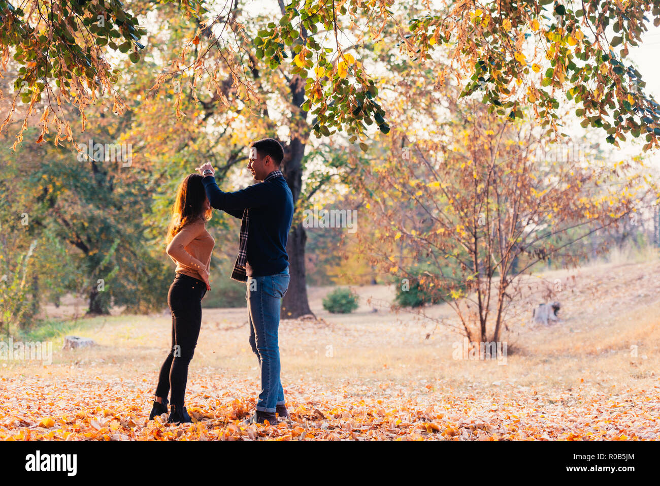 ouple having a leaf fight smiling and enjoying their time Stock Photo ...