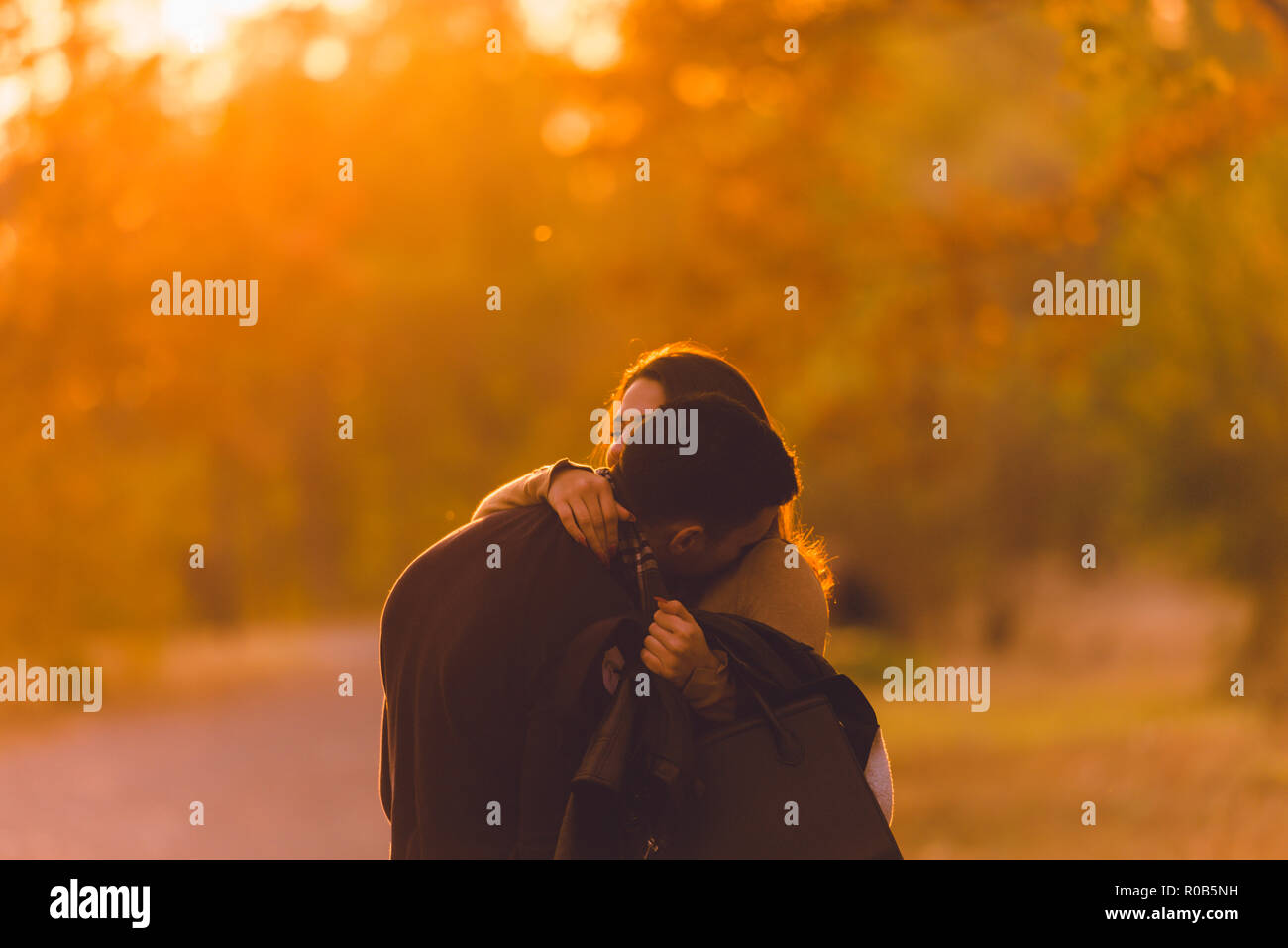 Young couple exchanging emotions before sunset Stock Photo - Alamy