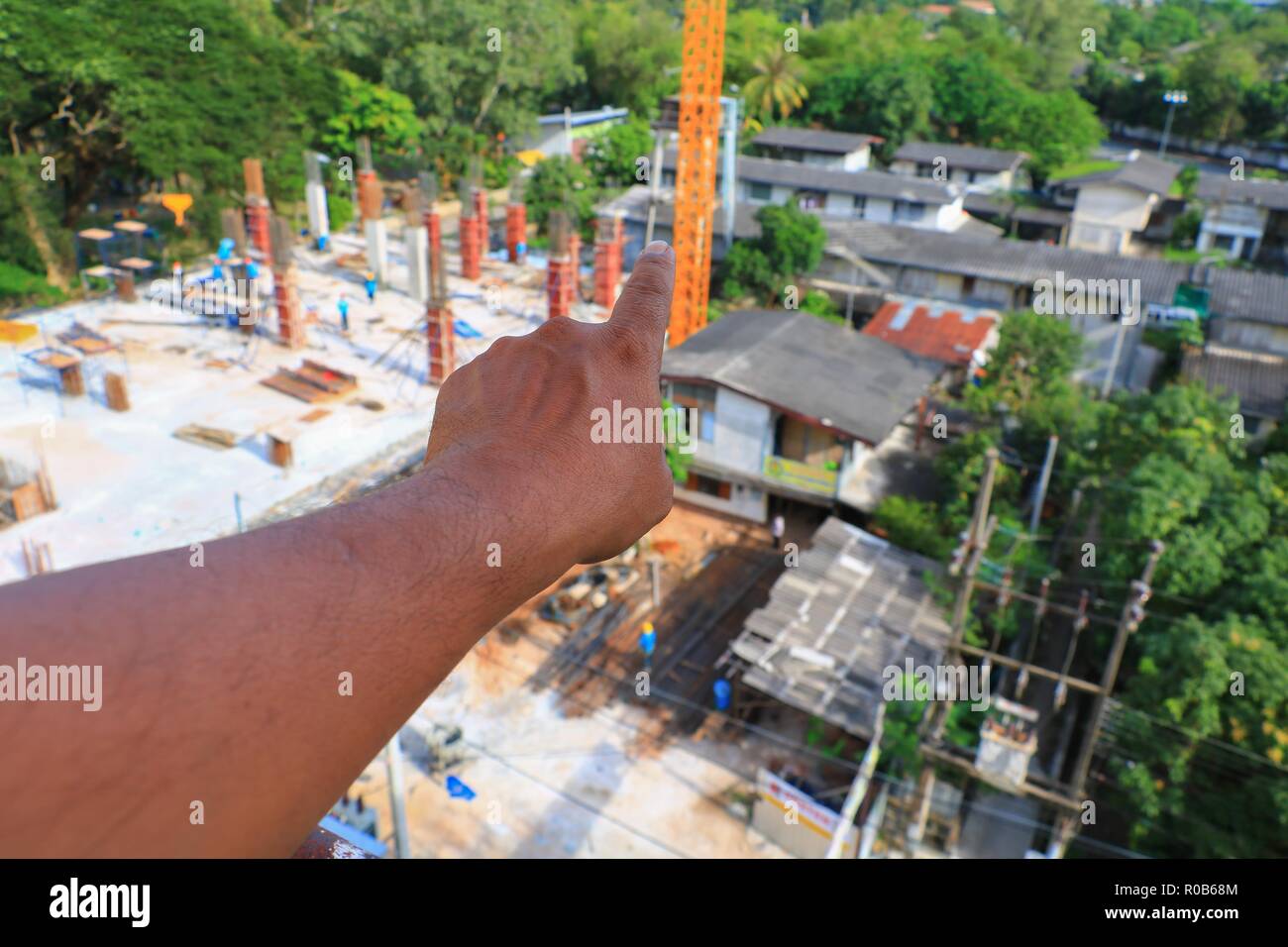 pointing at a building under construction Stock Photo - Alamy