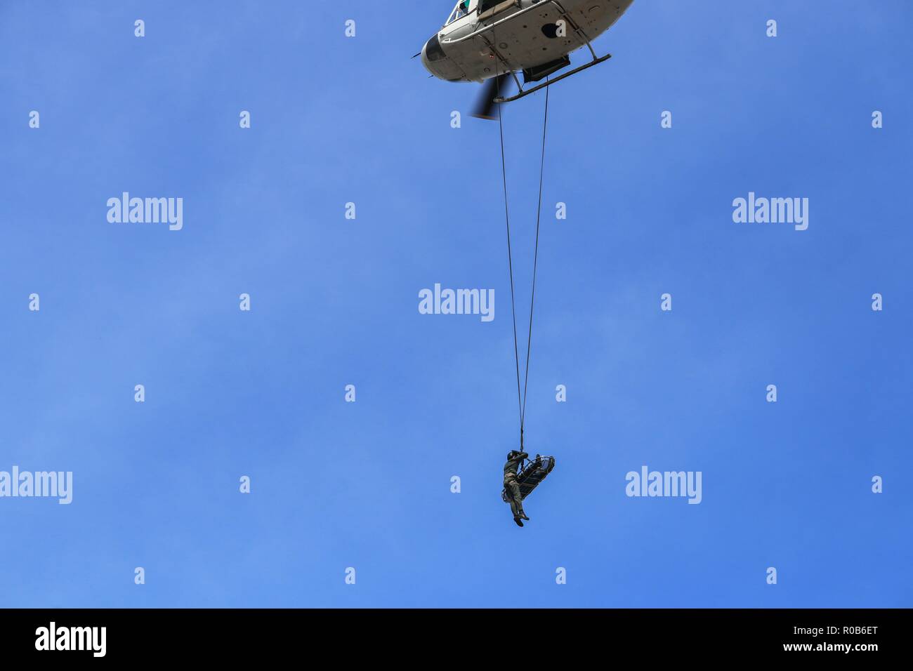 Soldier rescue emergency by army helicopter with rope on blue sky Stock ...