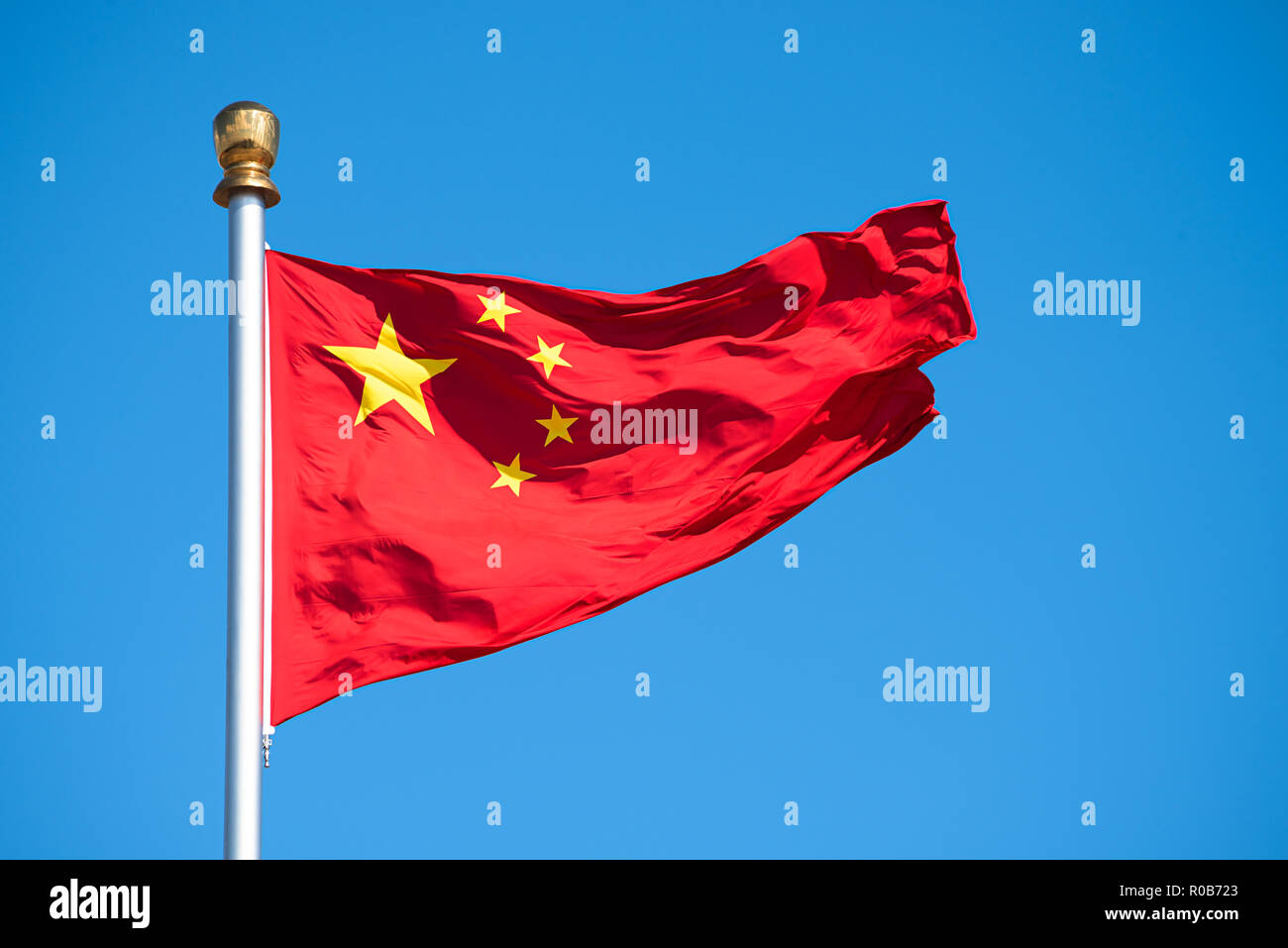 The flying Chinese National flag against the blue sky Stock Photo - Alamy