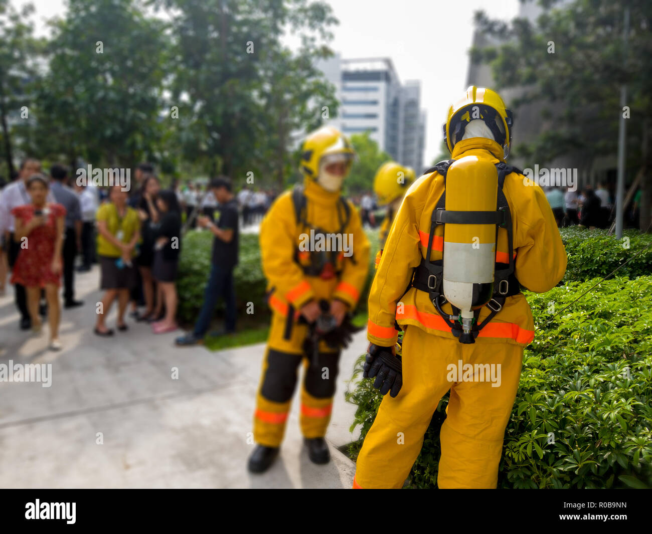 Select focus of back Firefighters in yellow suit with an oxygen tank in ...
