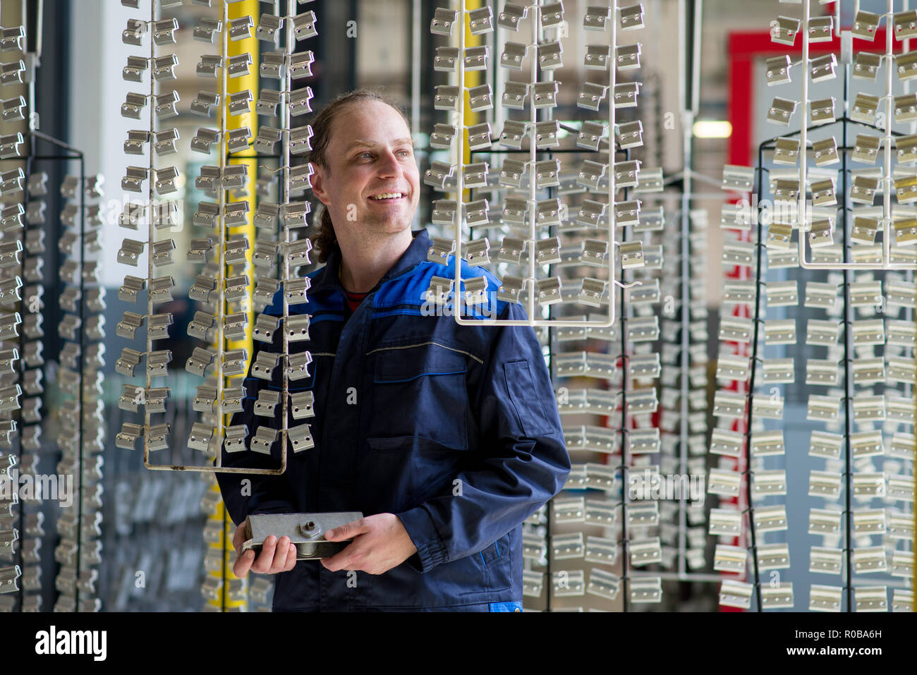 Factory worker checking products on production line Stock Photo - Alamy