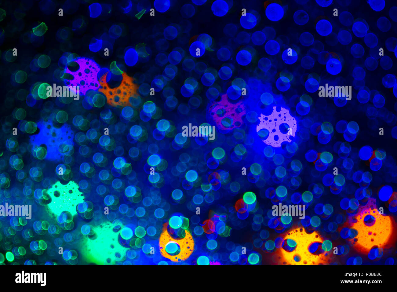 colored bokeh behind the splashes of water Stock Photo - Alamy