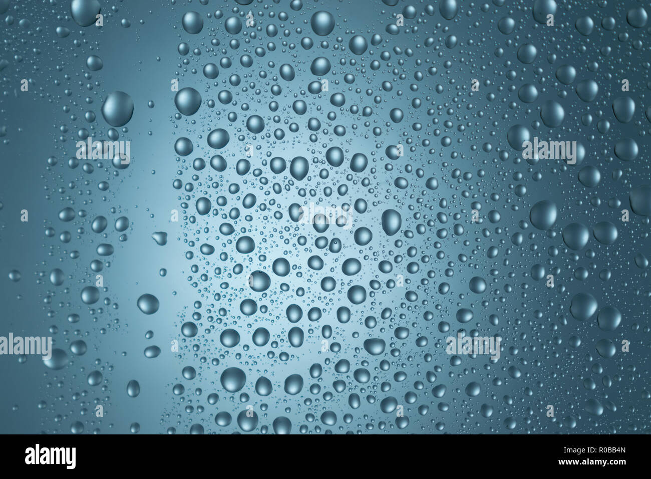 Water drops on round blue background, soft focus, close up Stock Photo ...