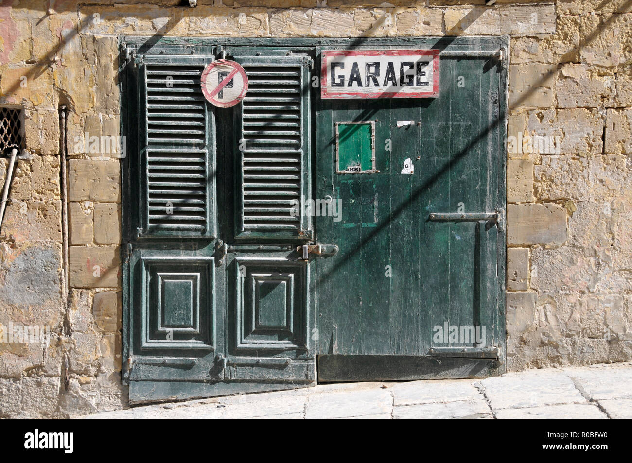 Around Malta - Garage Door with diagonal shadows, on a steeply sloping ...