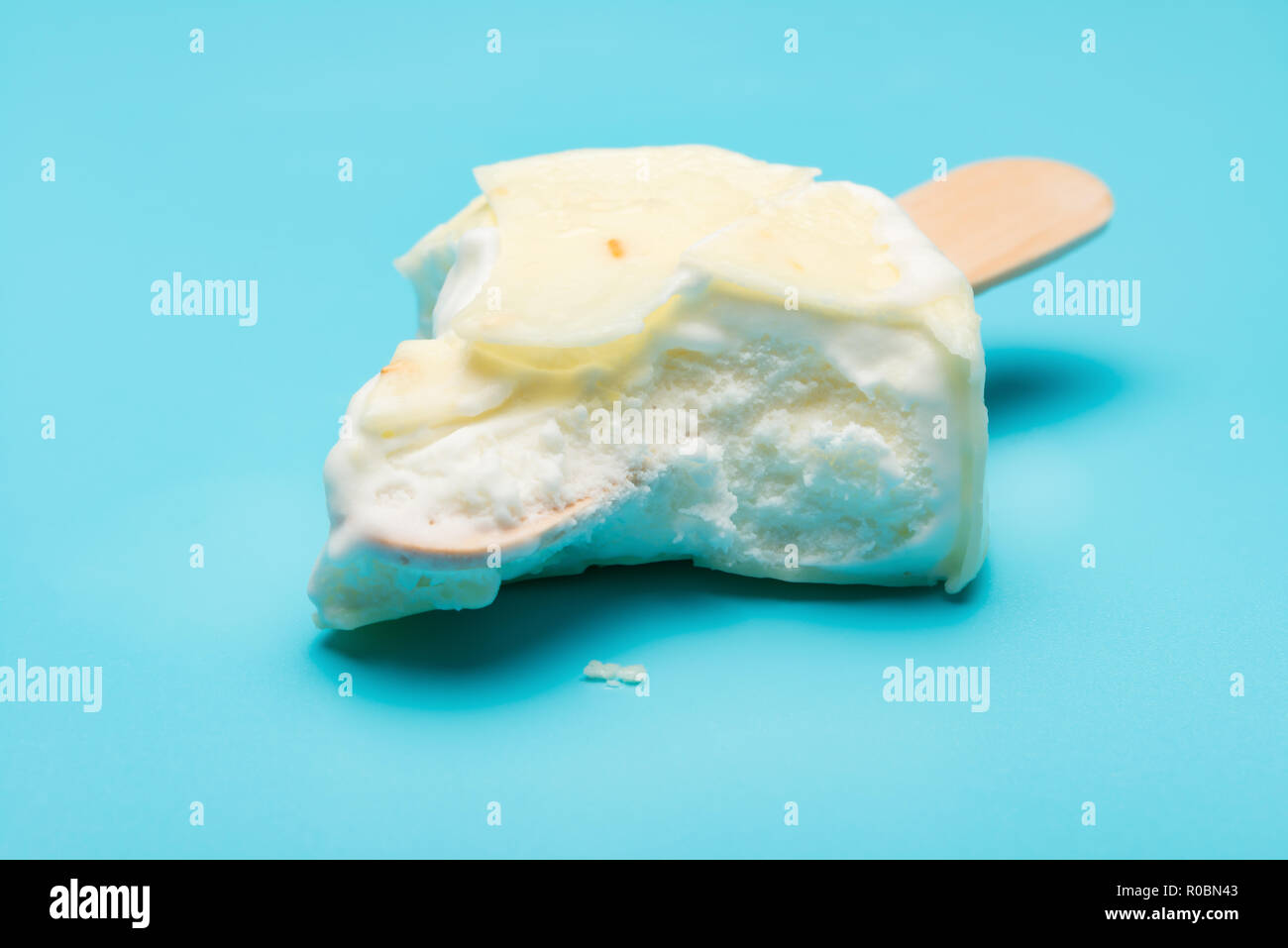 white popsicle with lots of bites on blue background Stock Photo - Alamy