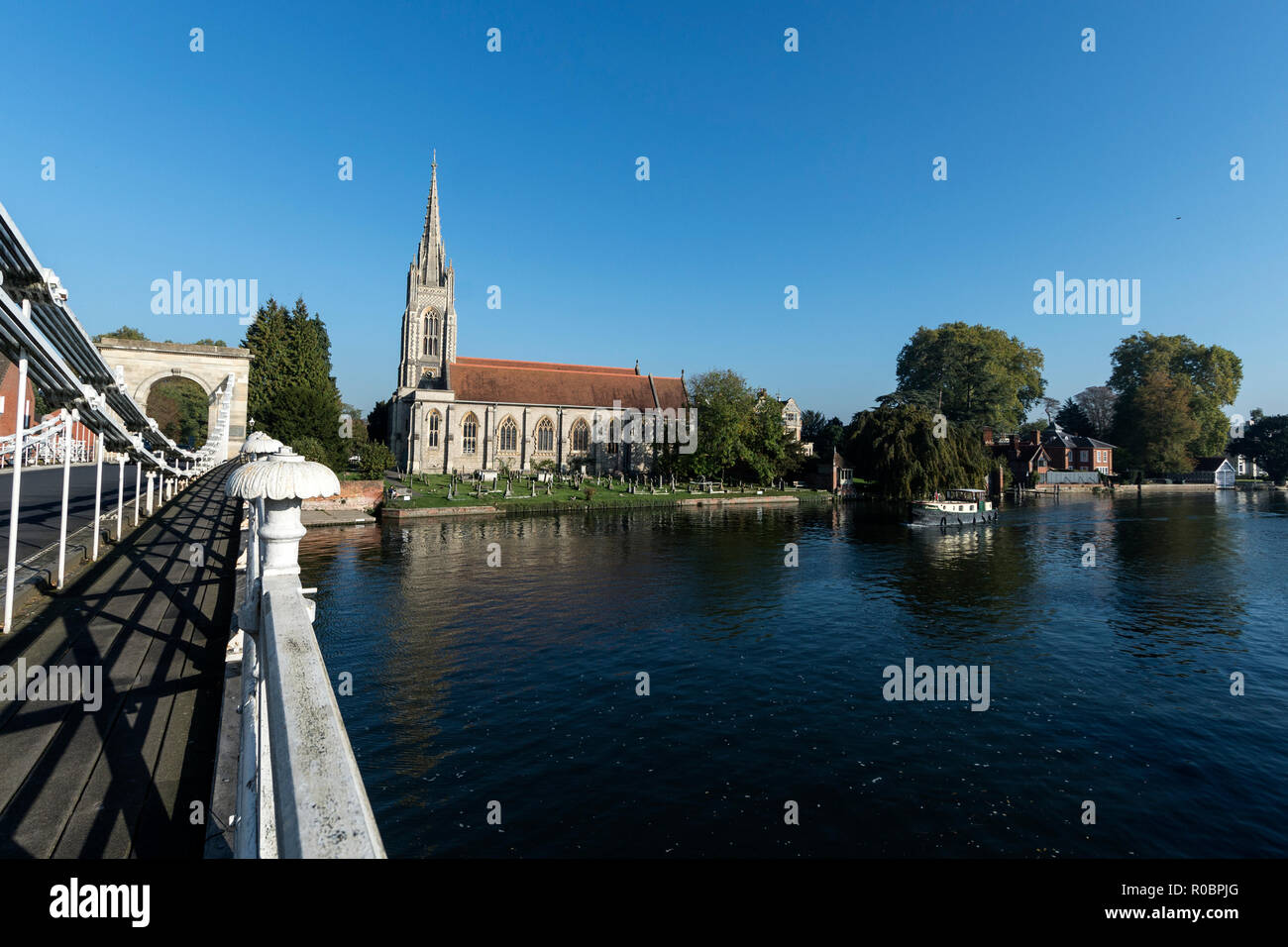 A river barge approaching the suspension bridge and All Saints Church ...
