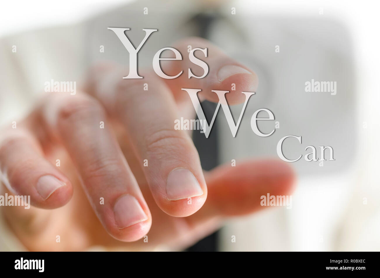 Male finger pointing at a Yes we can sign on a virtual screen Stock ...