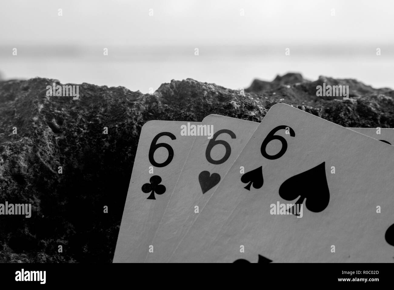 poker card gamble theme three of a kind triple six Stock Photo - Alamy