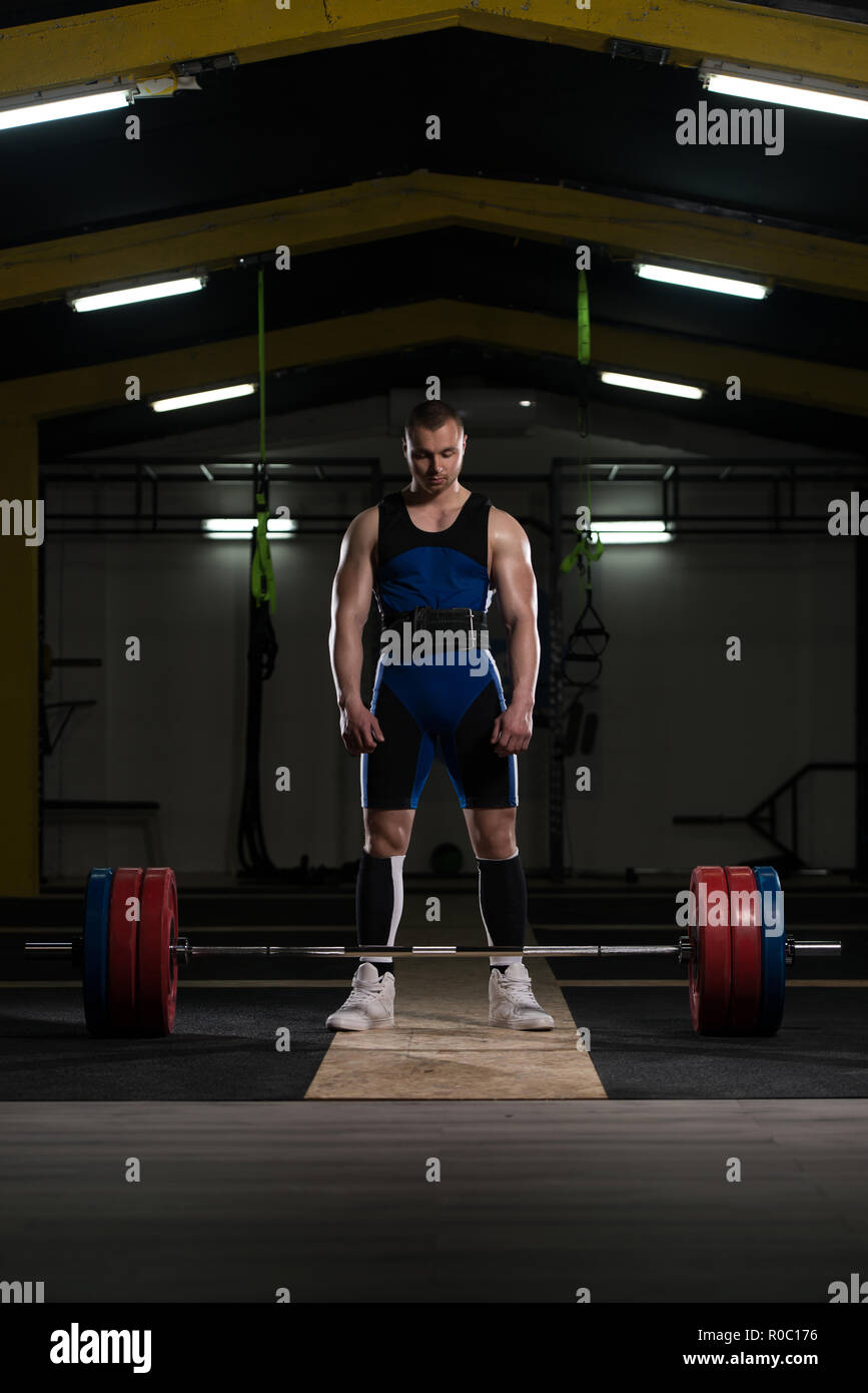 Strong Man Ready to Lift Heavy Barbell From Floor During Powerlifting ...