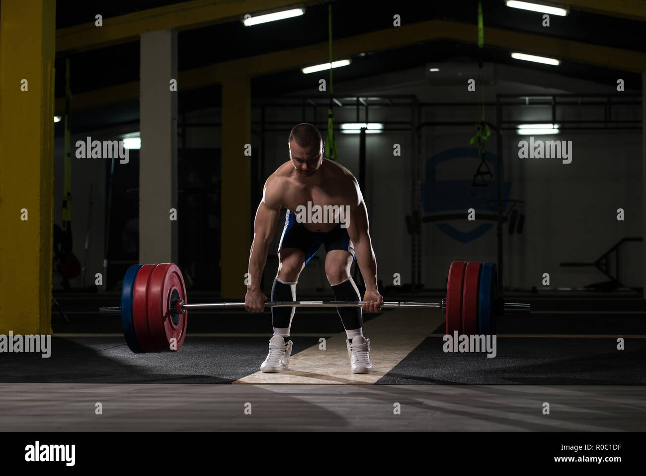 Professional Athlete Bent Over the Barbell and Is Preparing to Lift a ...