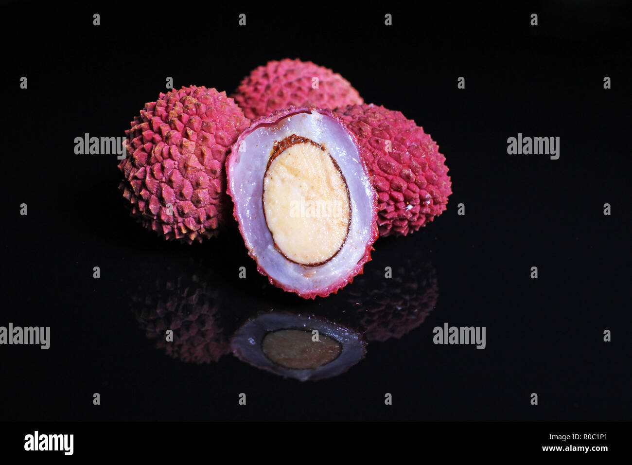 Lychee fruit fruits on isolated black reflective background Stock Photo ...