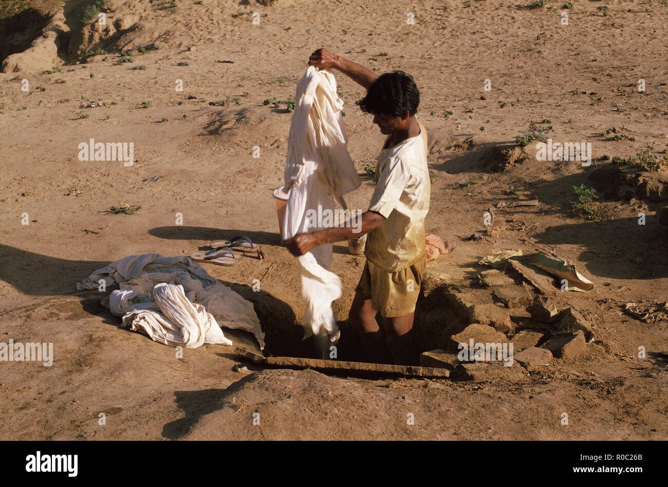 Low caste man washing clothes the traditional way ( Rajasthan, India ...