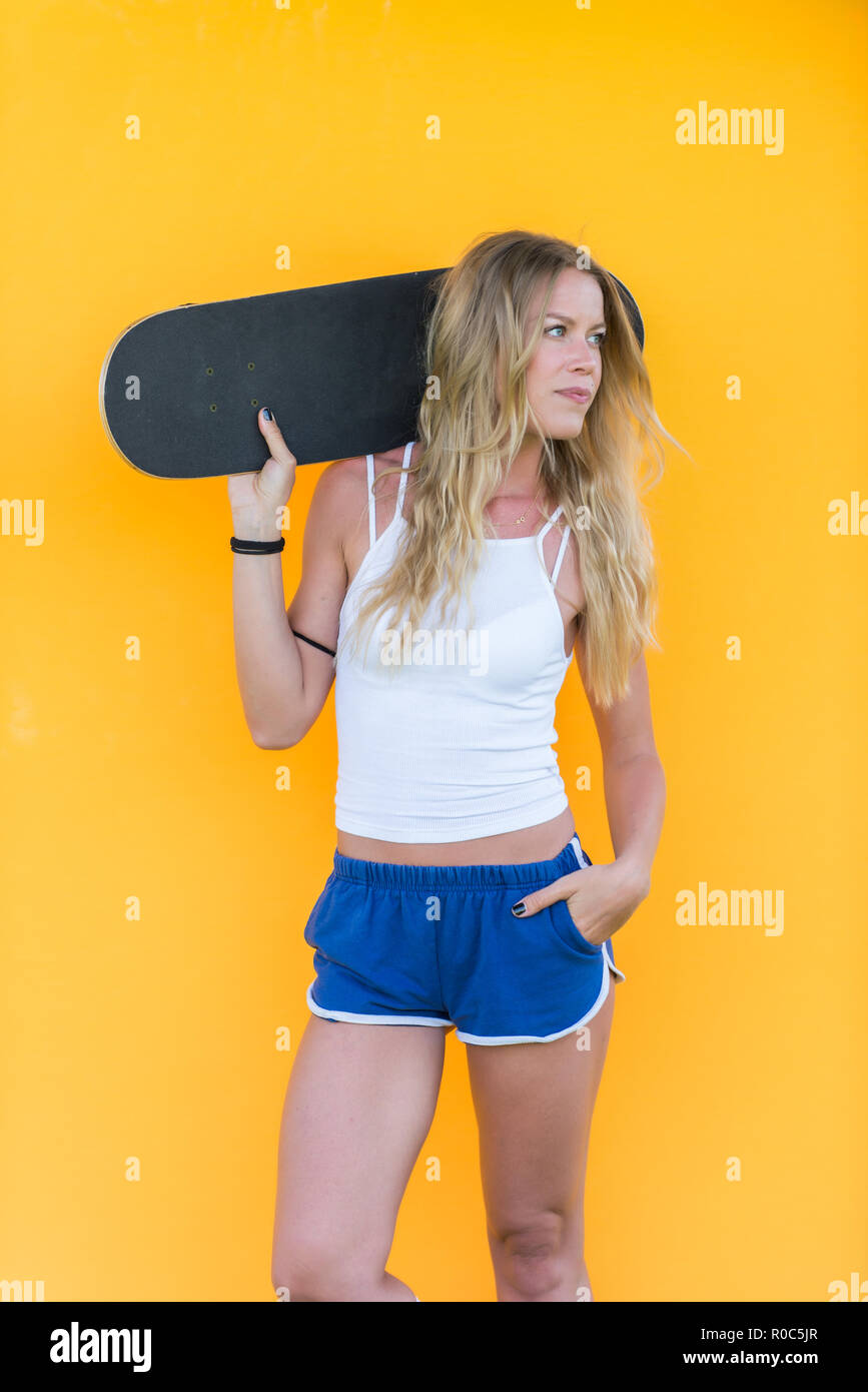 Stylish young woman skating outdoors - Pretty female skater playing ...